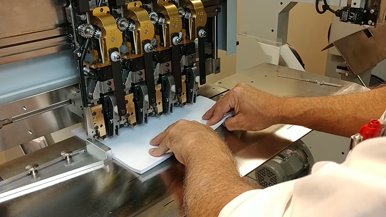 Deluxe Stitcher M17 machine with G8 heads stitching a 1/4" thick pad ...