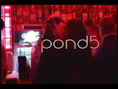 Couple is kissing in night club. Man and woman making out at bar, click for HD. Stock Footage