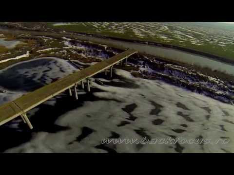 Isolated bridge on a frozen lake - Aerial Video (Podul si ecluza de la Budesti)