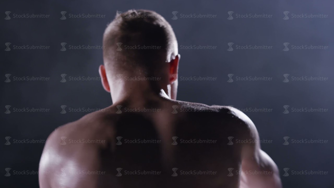 Shadow Boxing on dark background back view. Strong muscular boxer ...