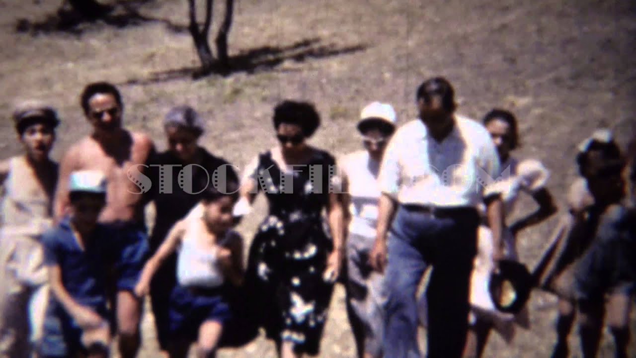 1954: Big happy Italian family together walking dry Mediterranean grass ...