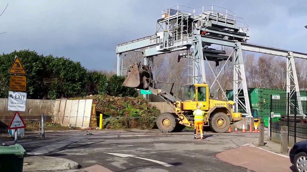 Bulldozer Operator works at a 'household waste recycling centre' in the ...
