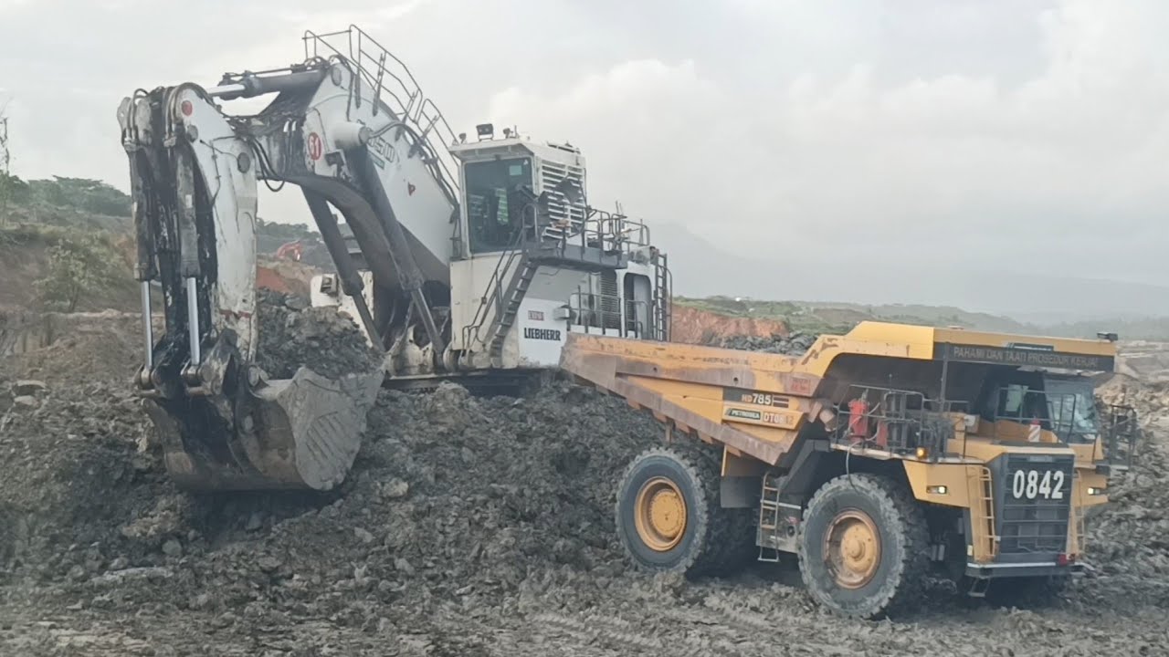 Liebherr R9350 Excavator Loads Overburden Material into a Komatsu HD785 ...