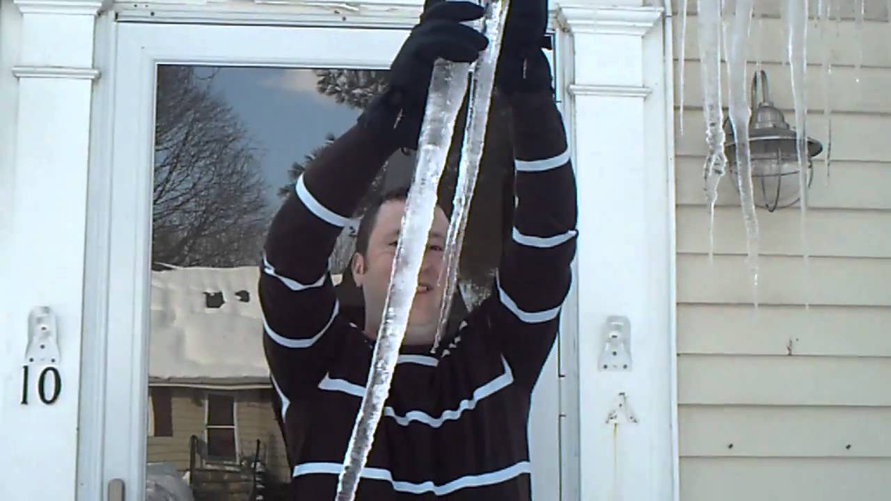 Breaking off Icicles on front of house - YouTube
