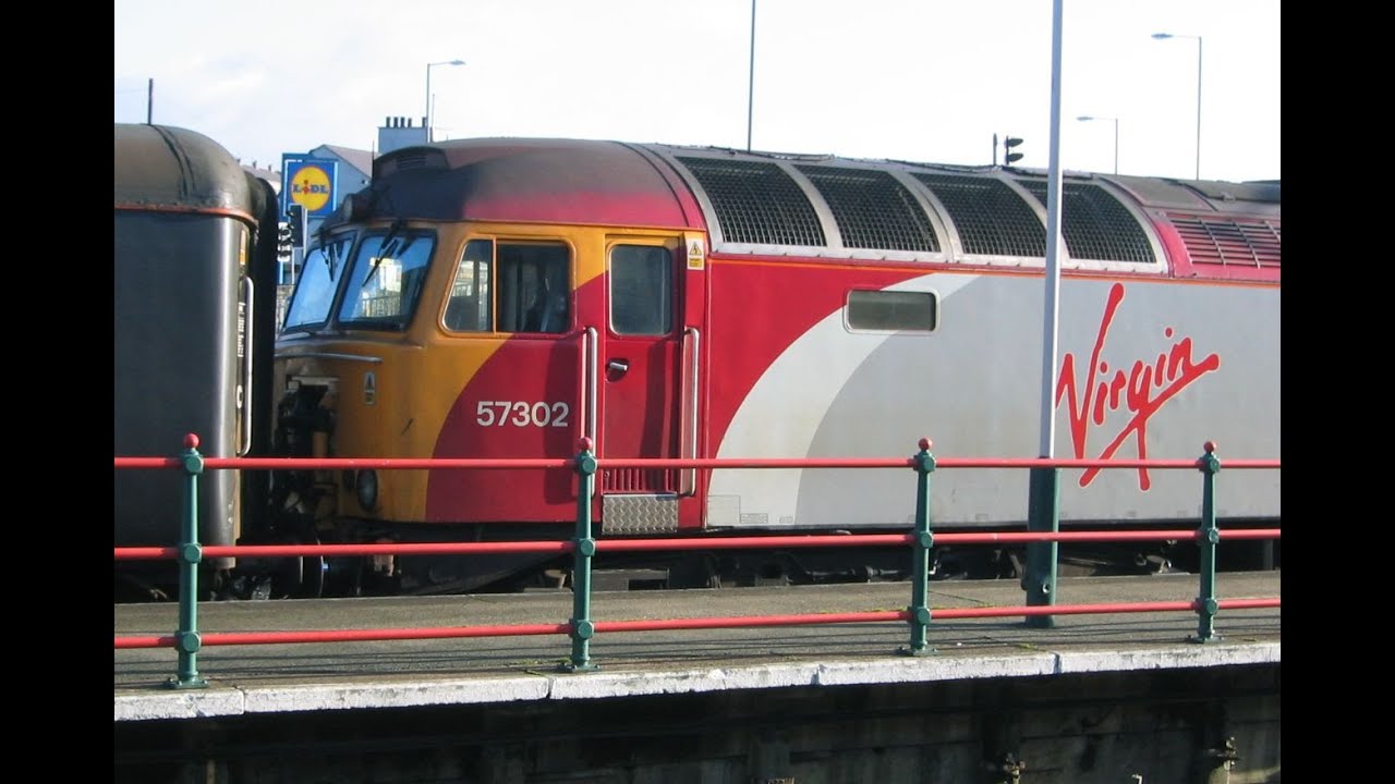 UK: Holyhead, Virgin Trains liveried Class57 (no.57302) departs on the ...