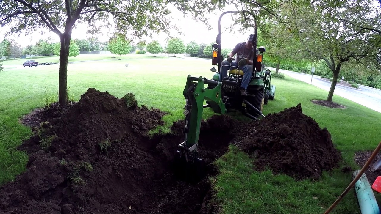 Compact Tractor Backhoe Digs Sewer Clean-Out - YouTube