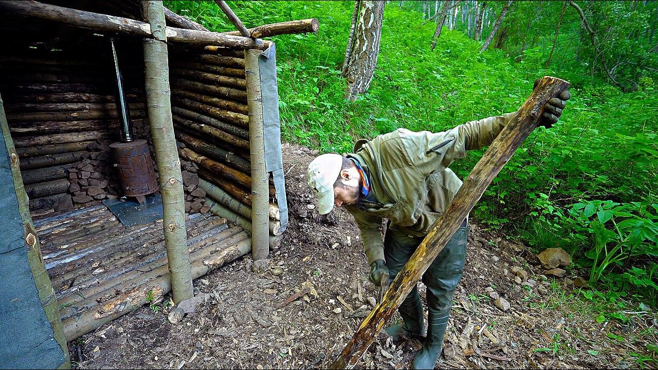 A log shelter in the wild forest. I'm building a dugout out of a fallen ...