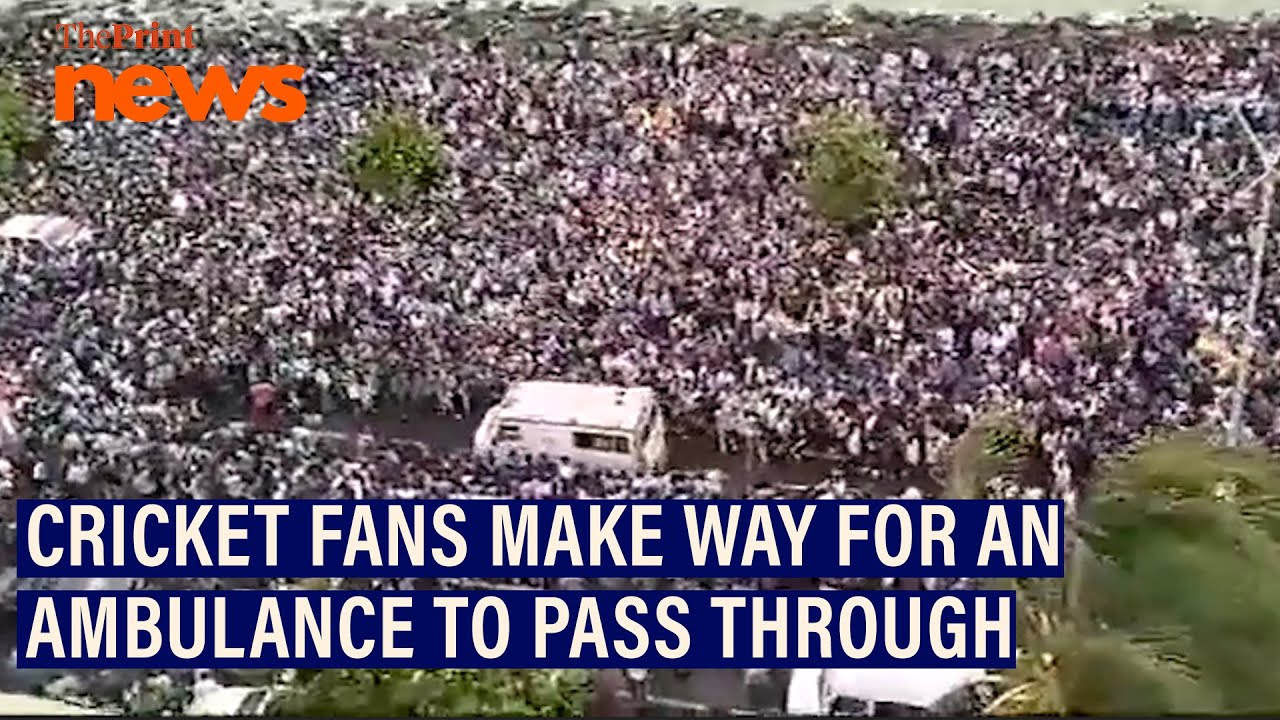 Cricket fans gathered at Marine Drive make way for an ambulance to pass ...