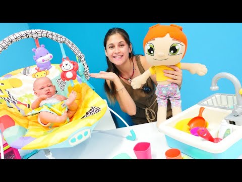 Bebek bakma oyunu. Ayşe, Lili'nin bebeğini sakinleştiriyor. Oyuncak bebek için anakucağı