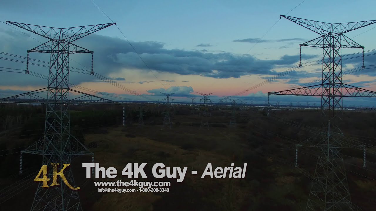 Aerial 4K UHD - Drone flying through large power lines at sunset - YouTube