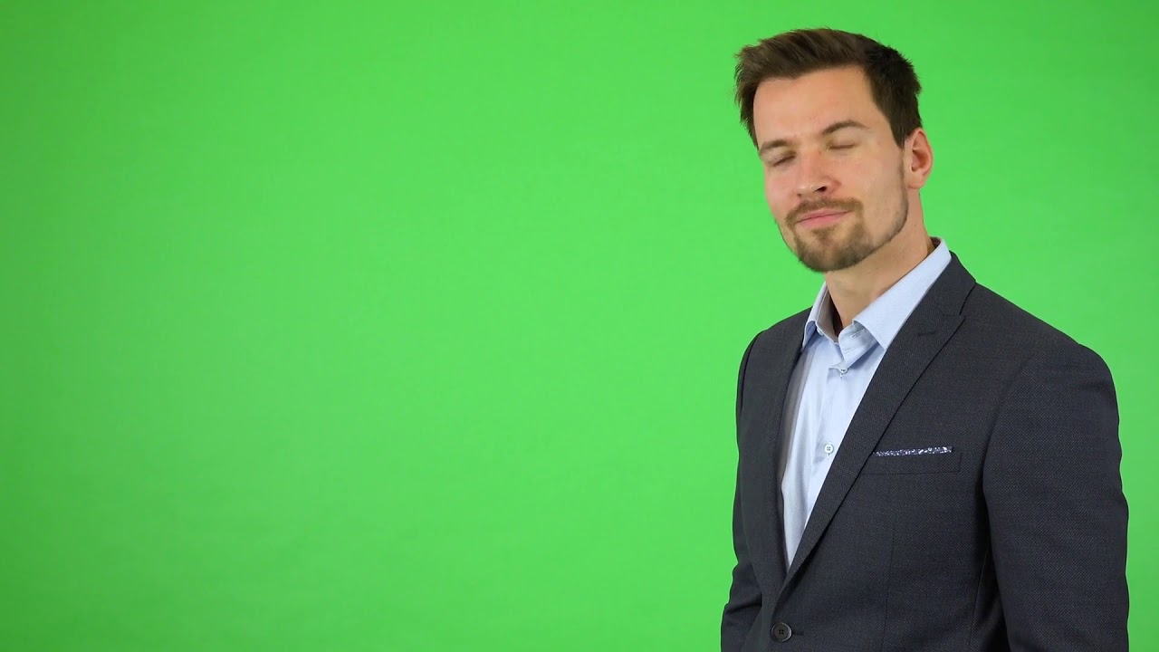 a young handsome businessman points at bullet point text smiles and ...