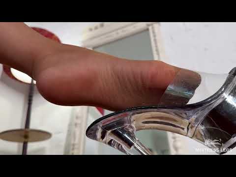 Goddess in pantyhose and high heels show you her nylon feet while resting on on the chair