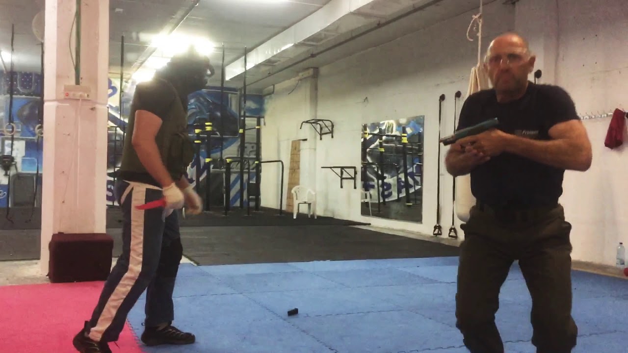 Itay Gil demonstrating Knife Terrorist vs Police with Firearm training drills using Simunition ...