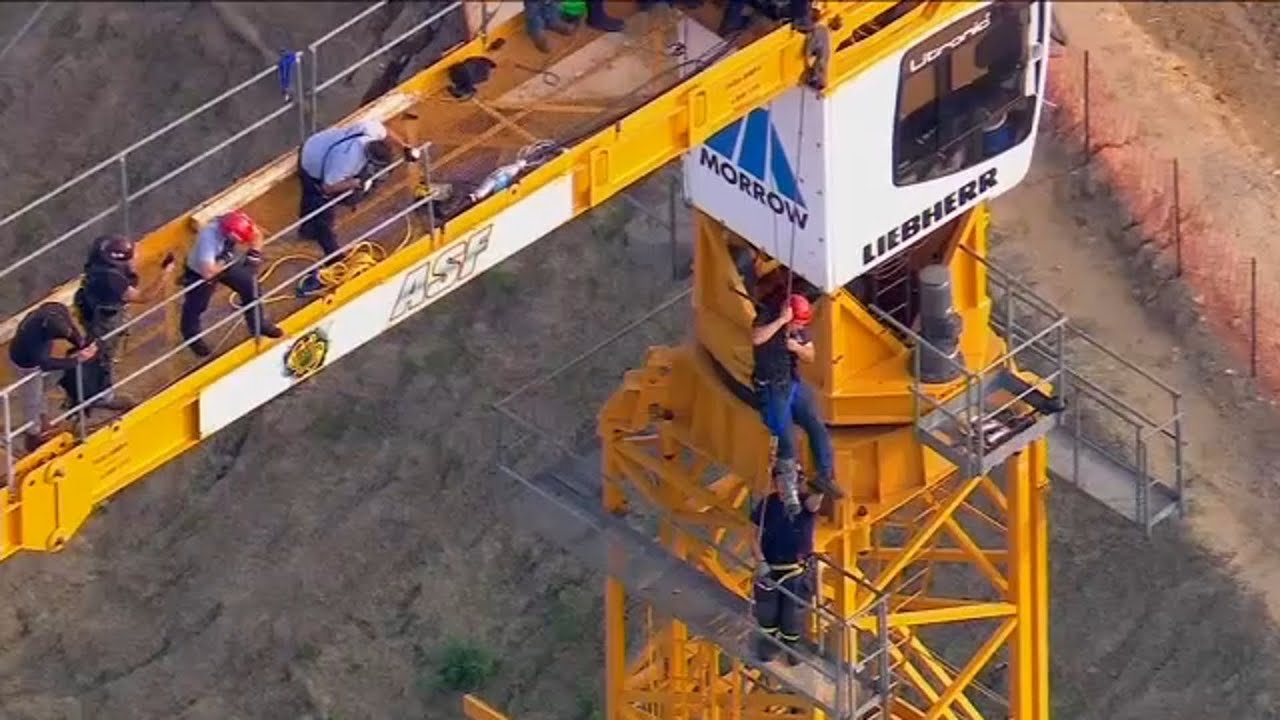 Man with injured leg rescued from top of crane in White Plains - YouTube