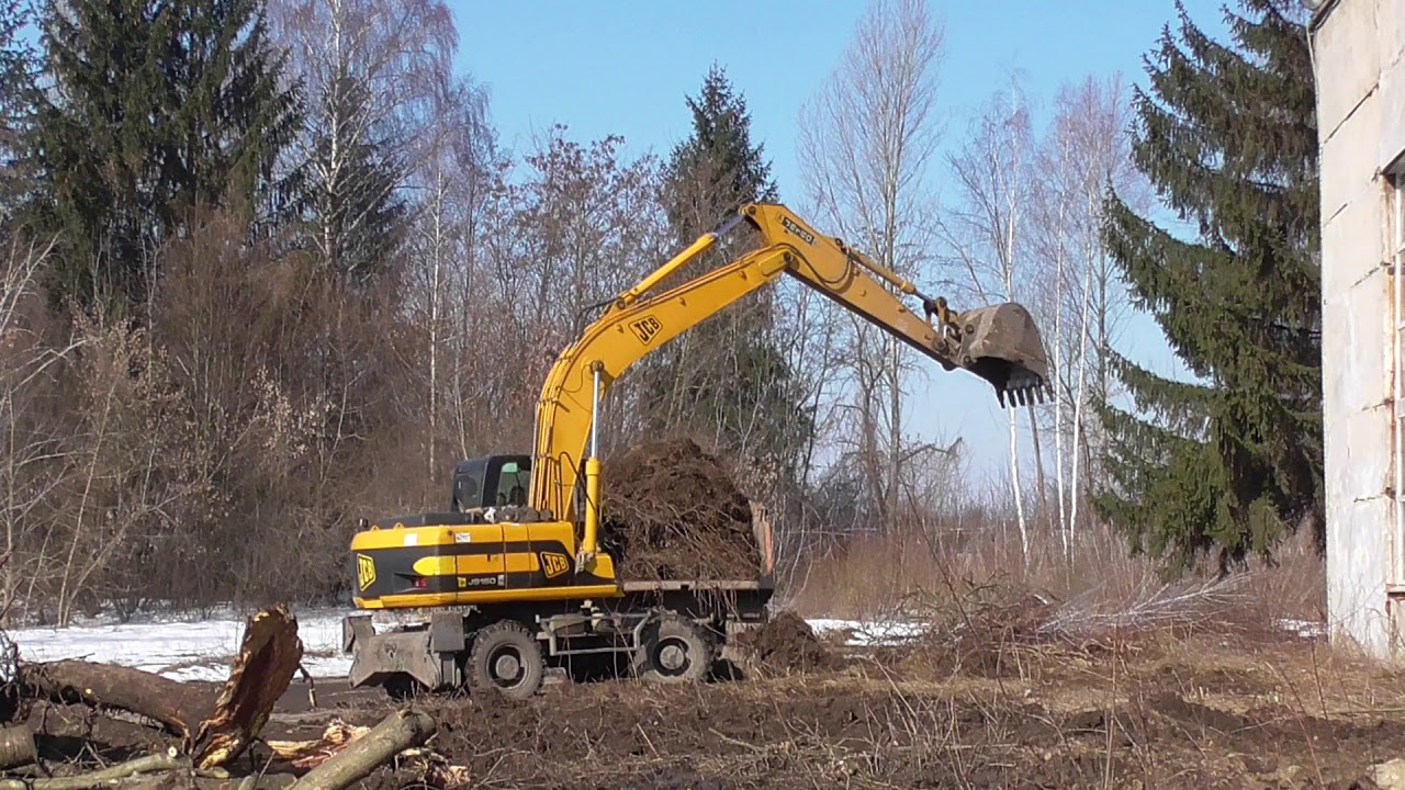 Excavator cleans the area - YouTube