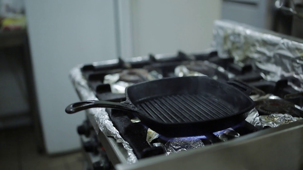 a burning hot pan in the restaurants kitchen on a gas burner heats up ...