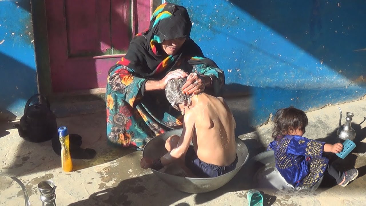 Bathing village children by grandmother - YouTube