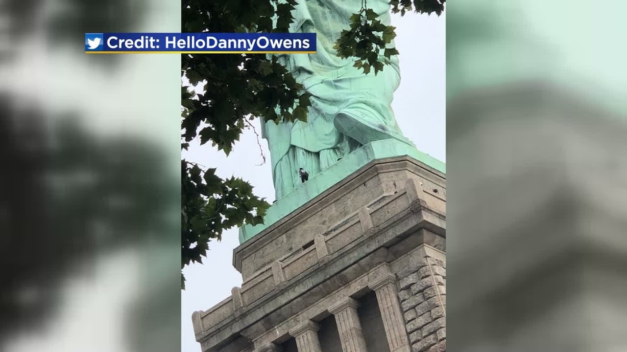 Person Spotted Climbing Up Statue Of Liberty - YouTube