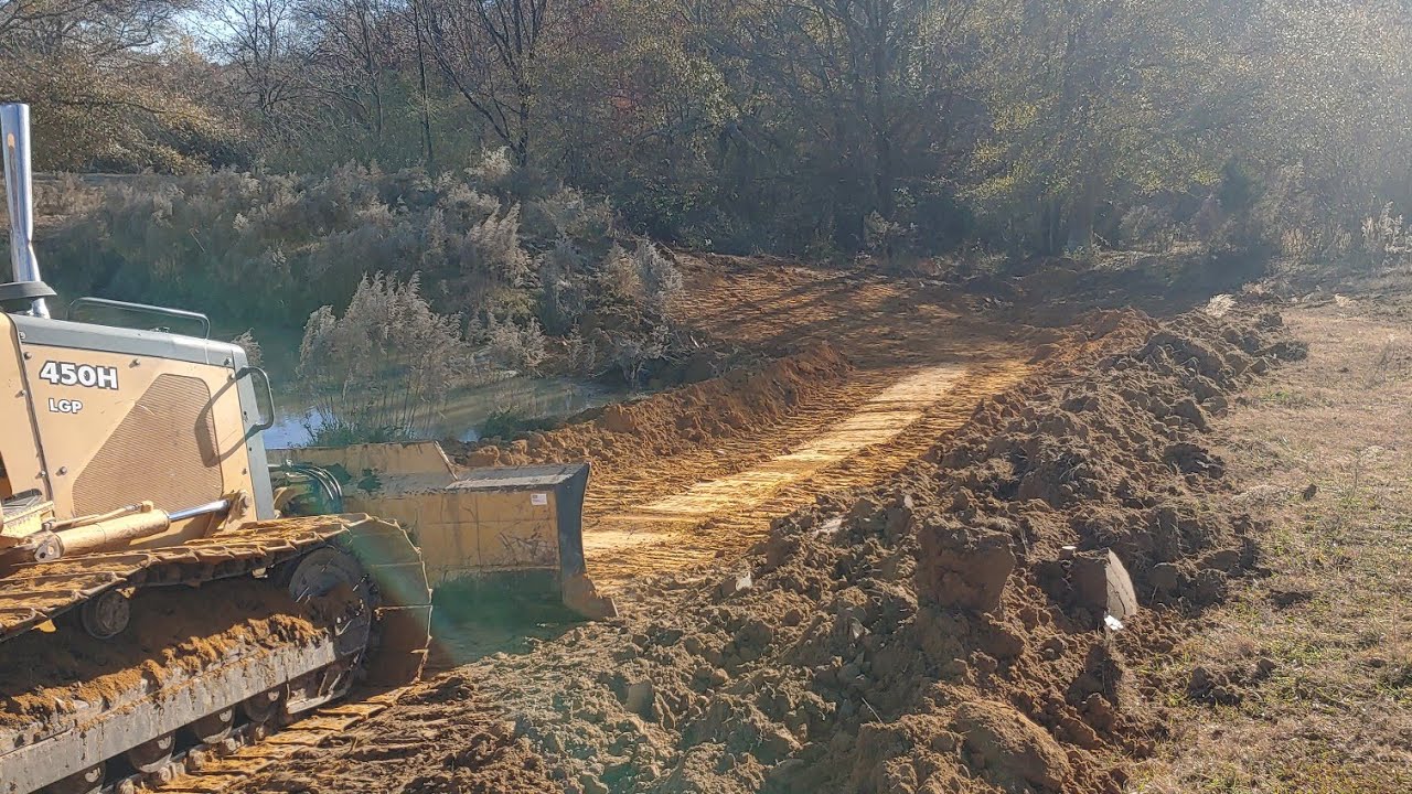 John deere 450h dozer repairing a pond dam - YouTube