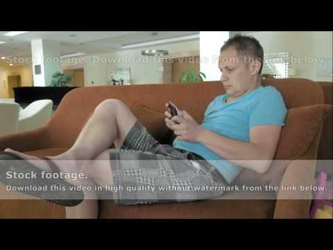 A man is on his mid pad tablet on a couch