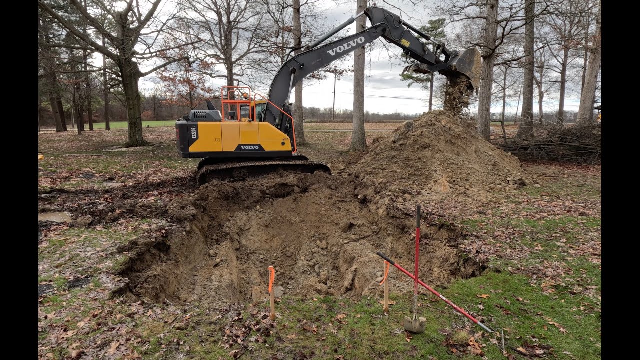 Setting storm drain inlet with 220 Volvo excavator - YouTube