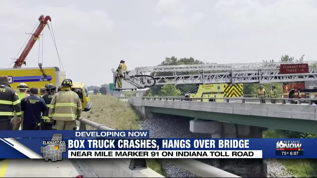 Box truck crashes, hangs over bridge - YouTube
