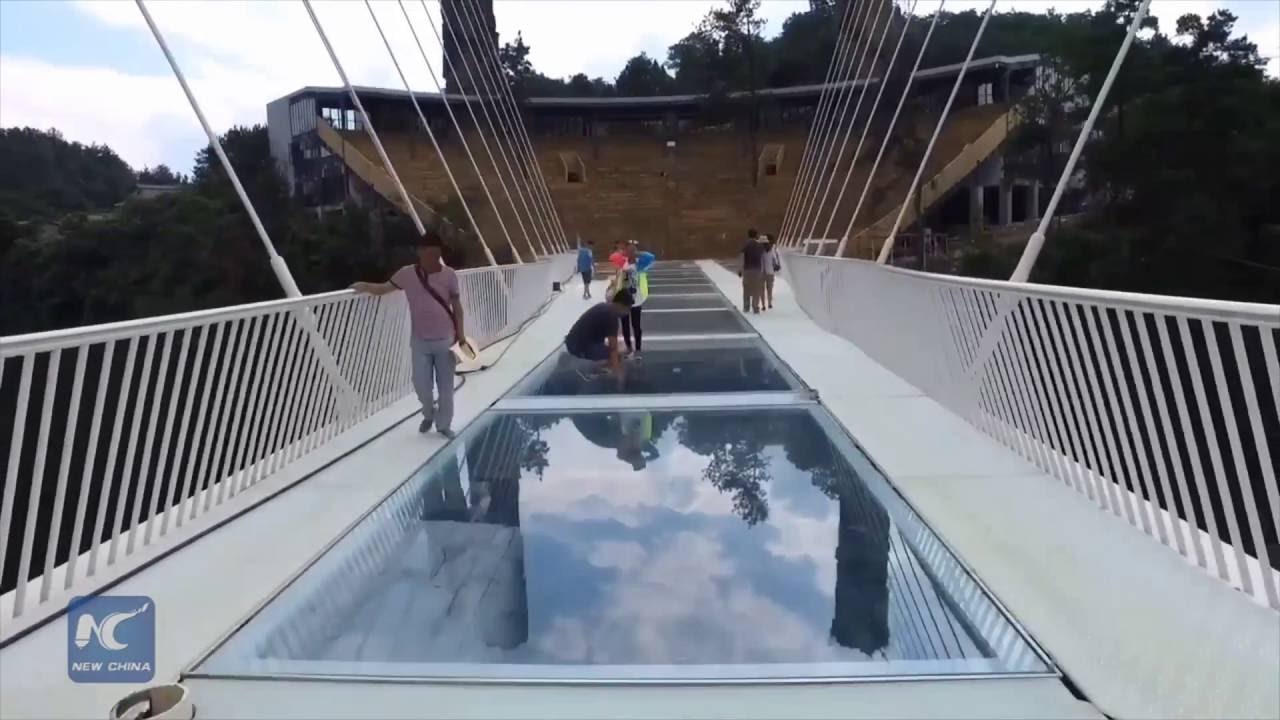 Terrifying glass-bottomed walkway opens on cliff face in C China - YouTube
