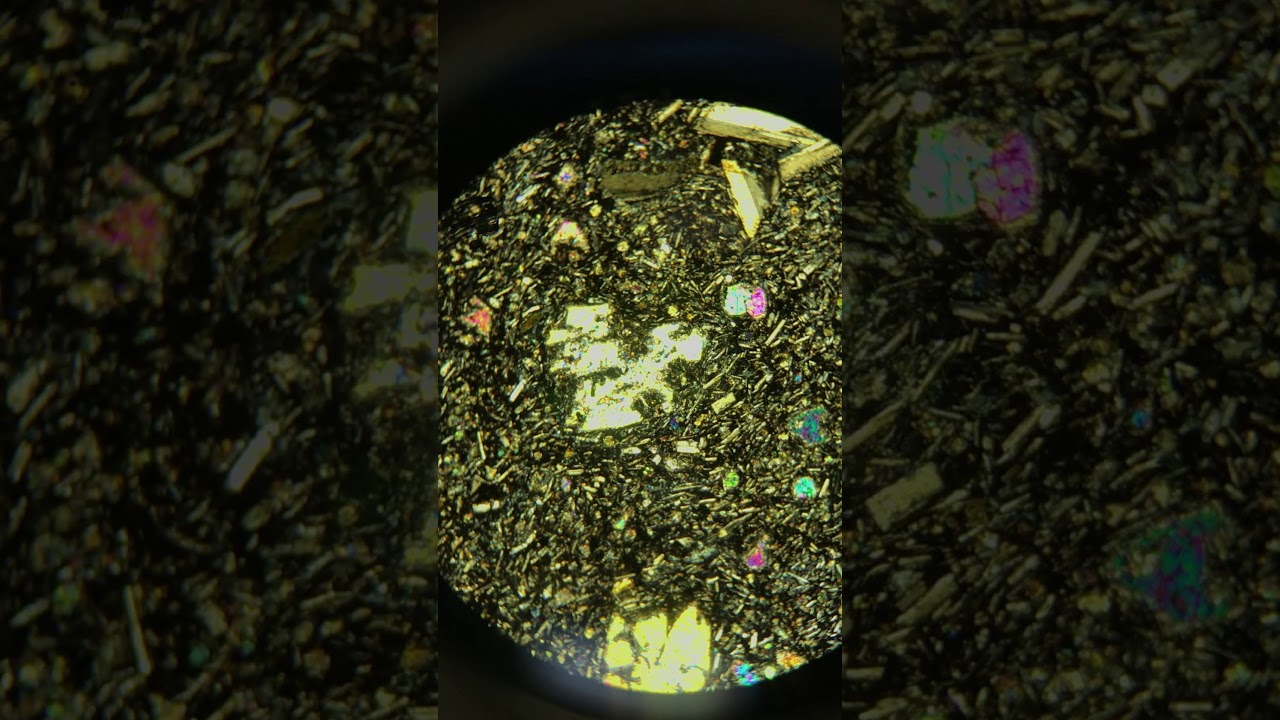 Embayed olivine phenocrysts in a basalt in XPL in thin section - YouTube