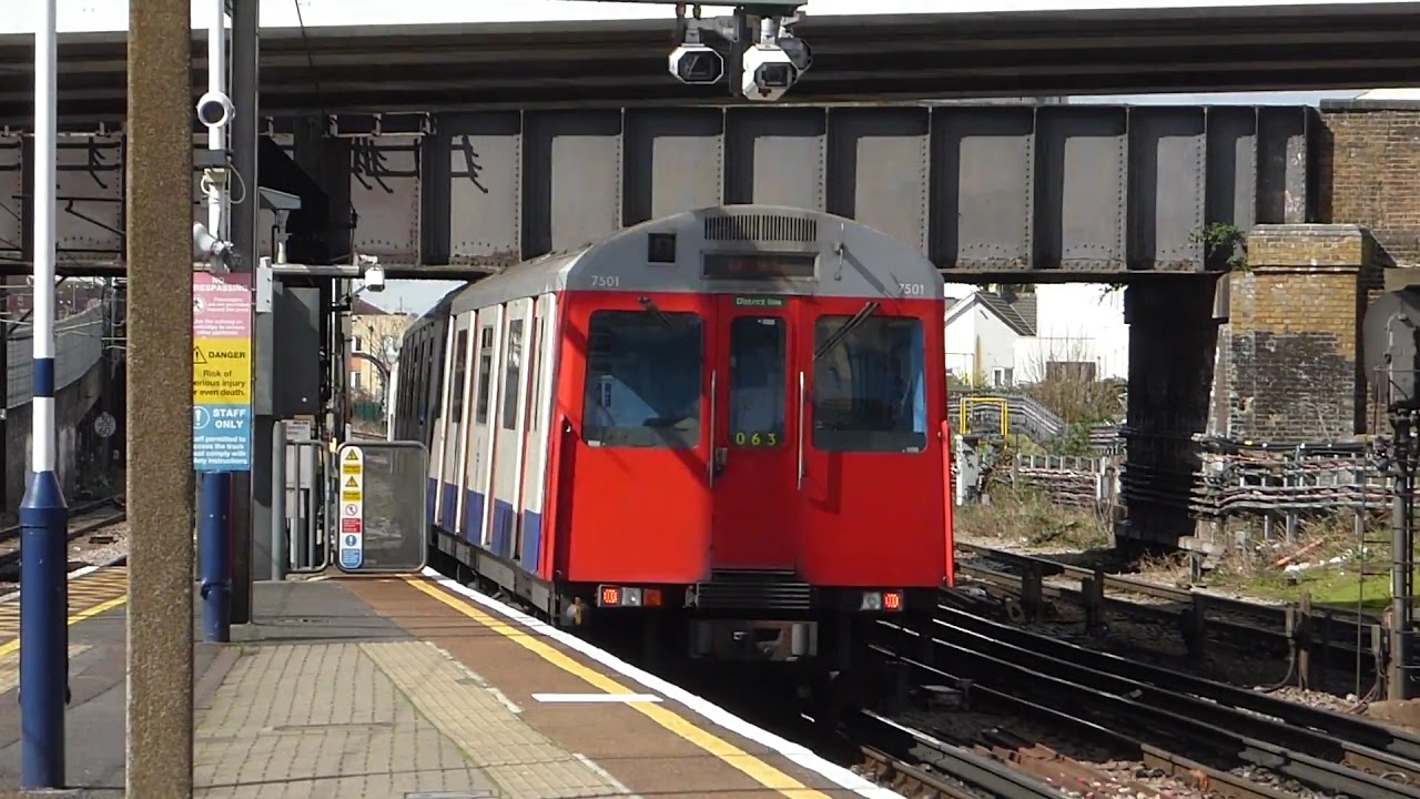 London Underground District Line D78 train leaves Barking, along with ...