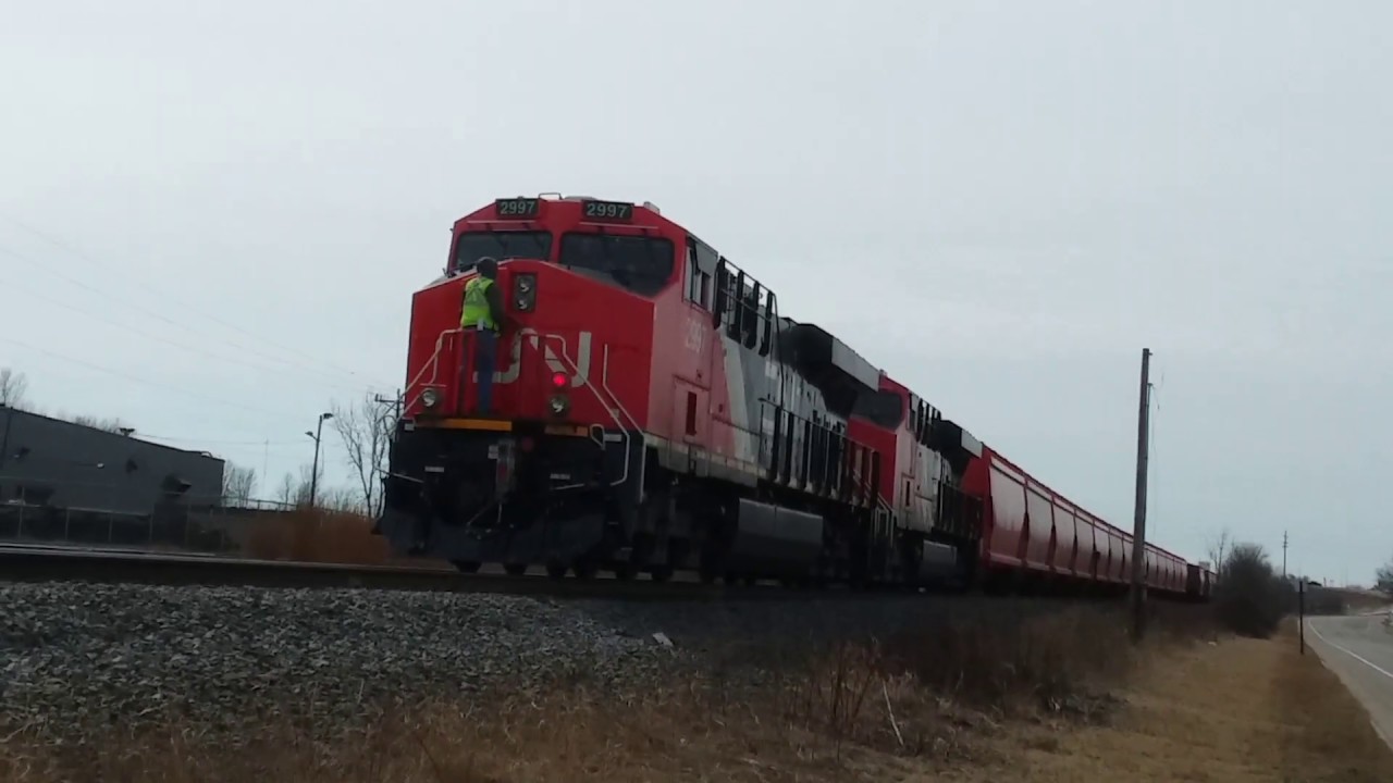 CN grain train with 2 end dpu's changing tracks and than parking on the ...