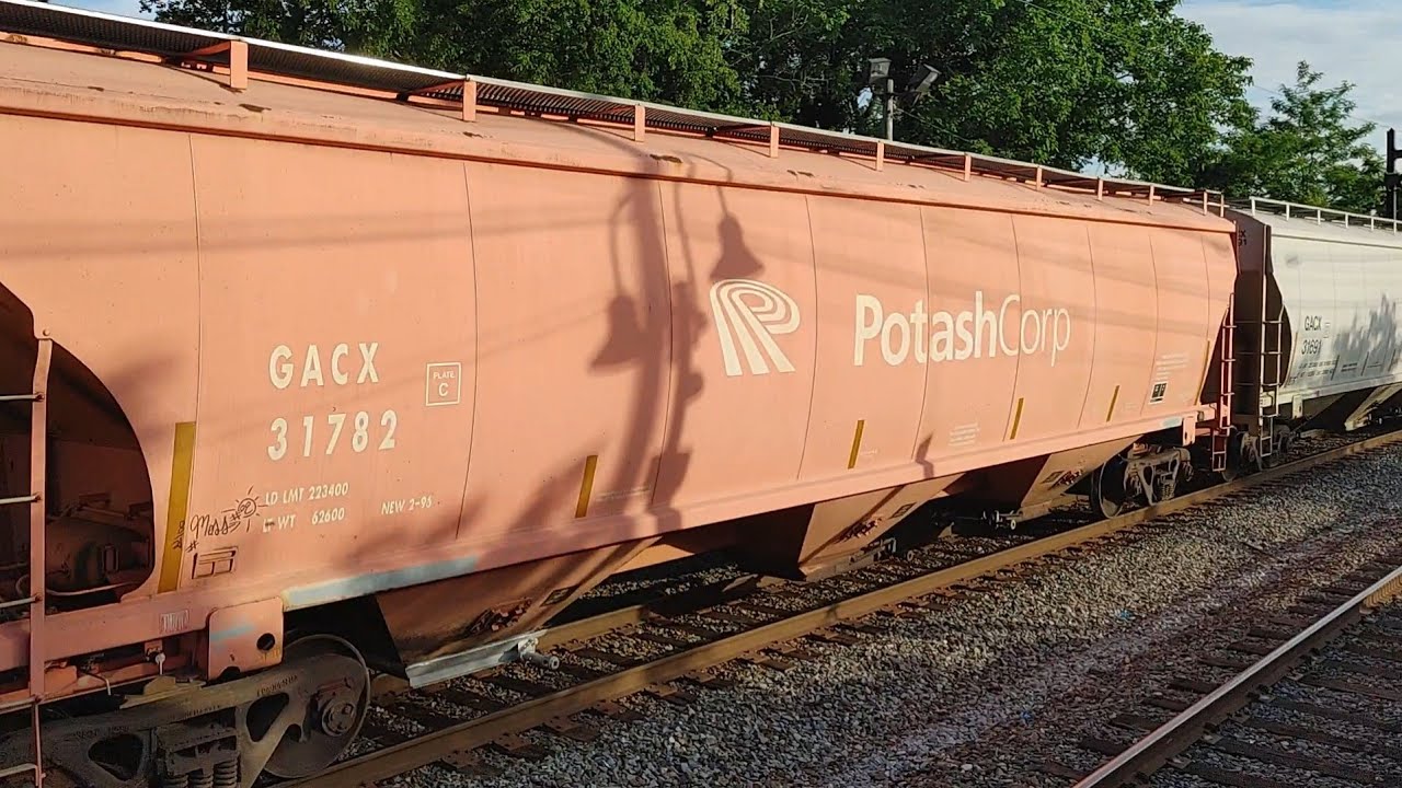 CSX M422 with no horn, 7 Potash Corp hopper cars from Canada, and a mid ...