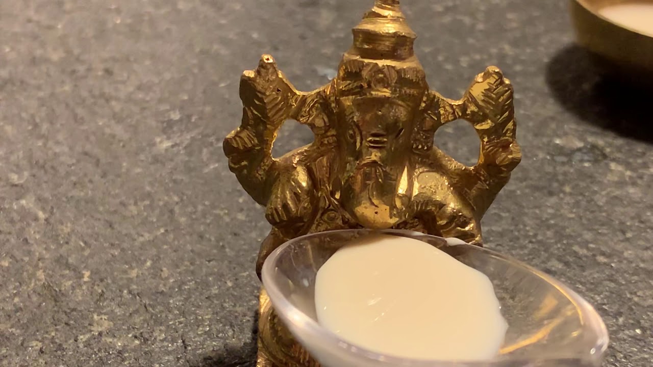 Feeding milk to Ganesh - YouTube