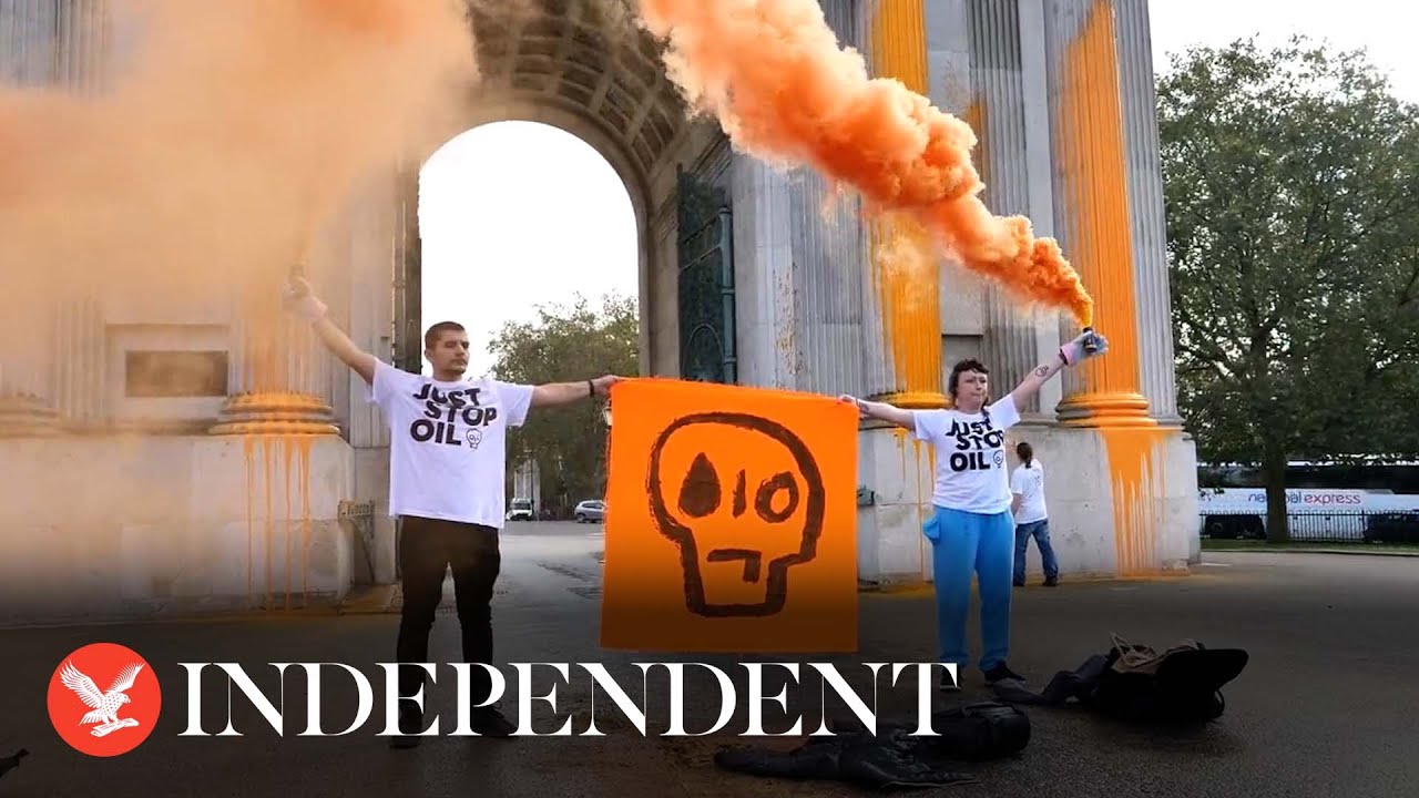 Just Stop Oil protesters paint Wellington Arch orange - YouTube