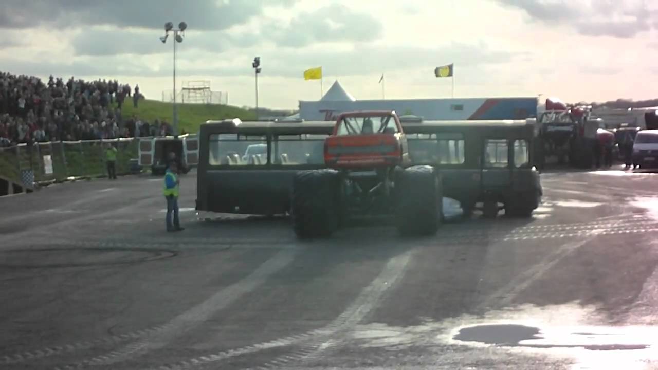 A monster truck jumps over bus - YouTube