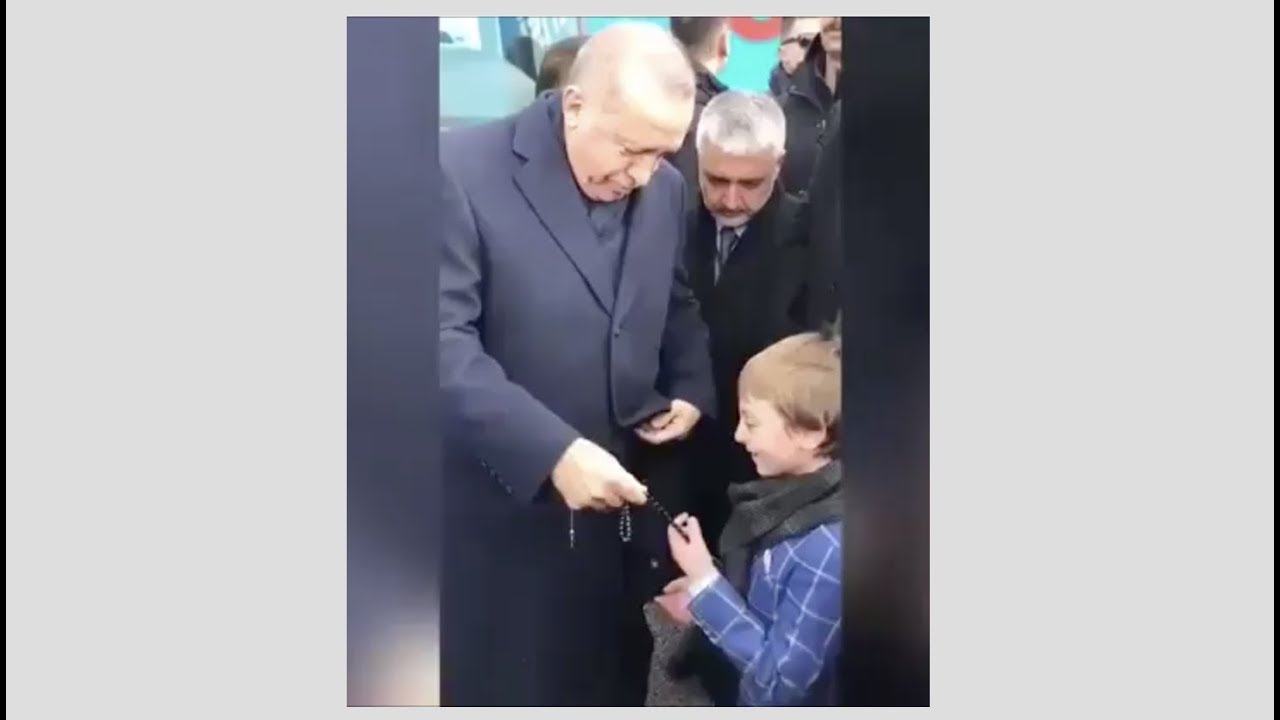 Turkish President Recep Tayyip Erdogan meets children A kid gives ...