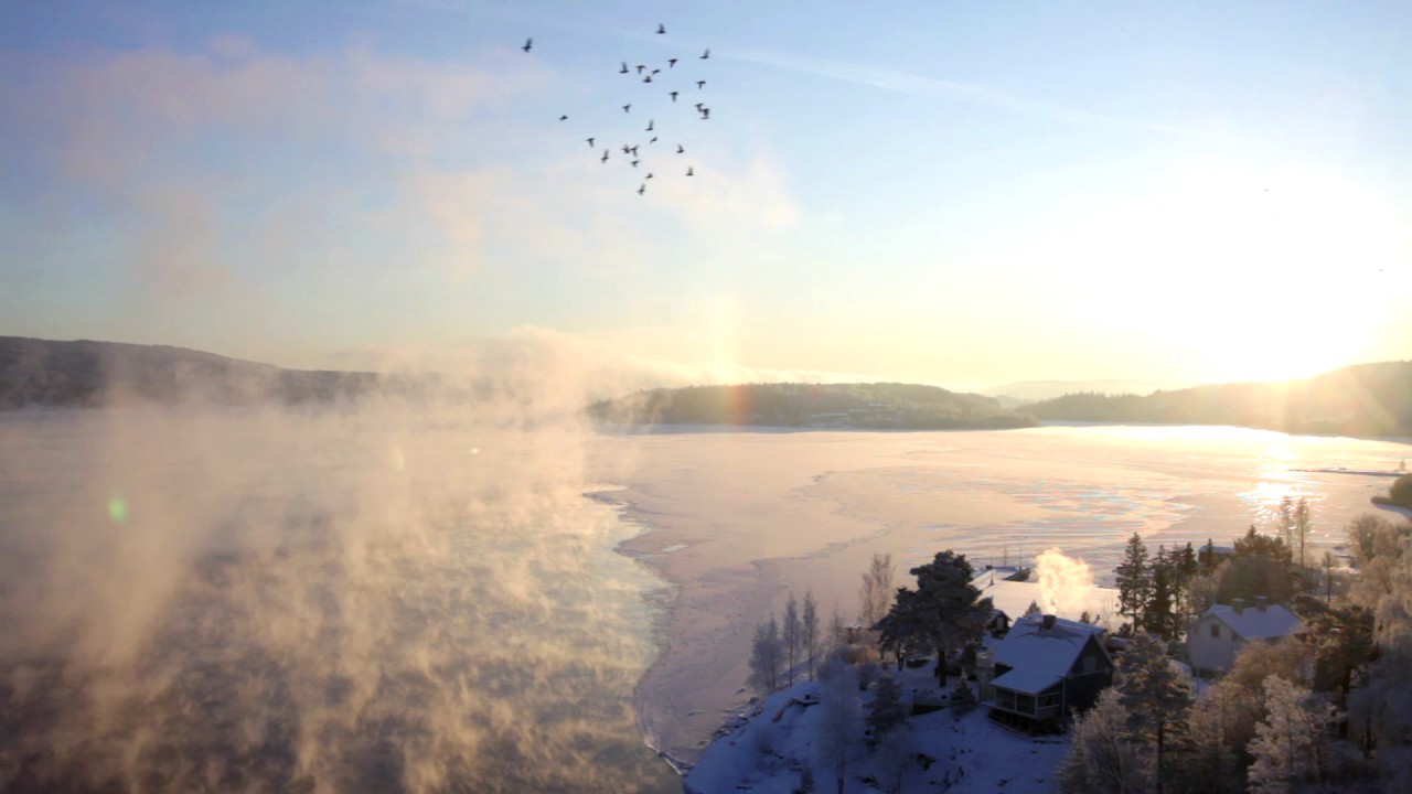 Vapors are rising from a freezing river on a very cold winter day - a ...