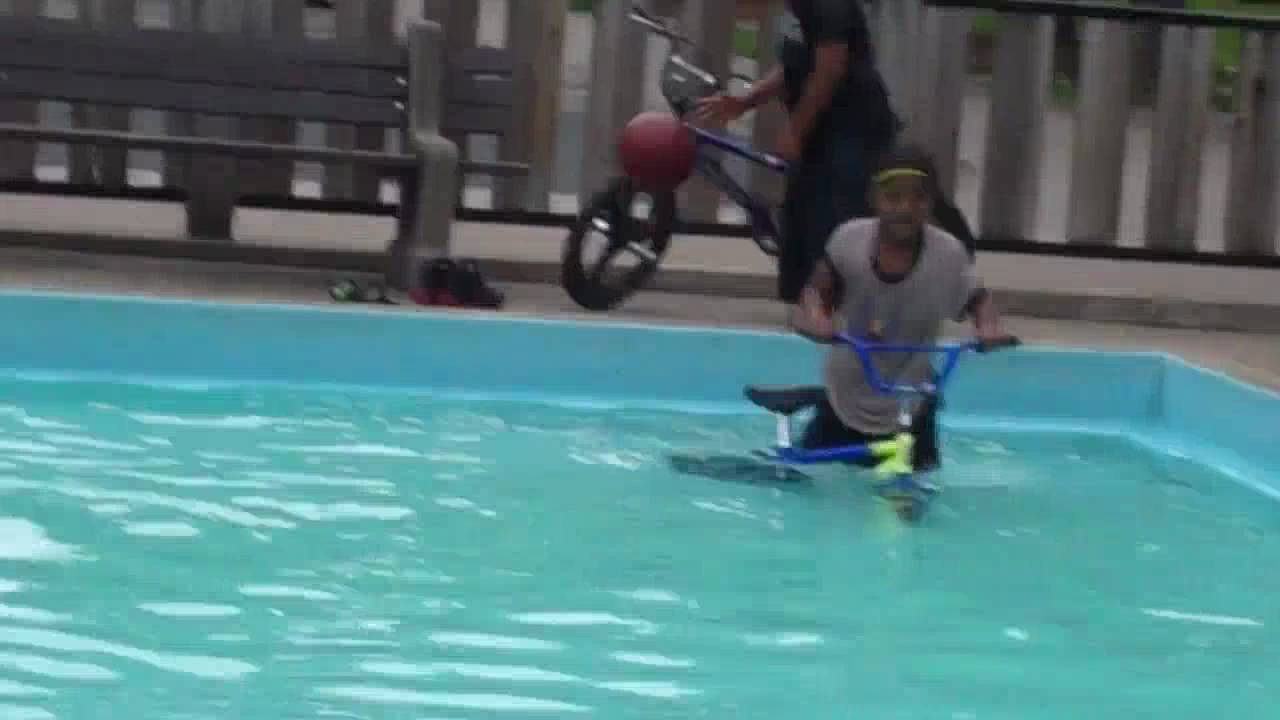 little girl biking in a pool - YouTube