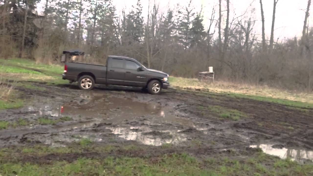 Mudding dodge ram in the field - YouTube