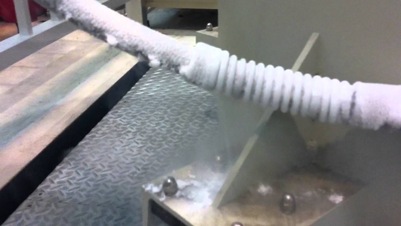 Liquid air is falling from the cryogenic pipe with cold helium gas, on ...