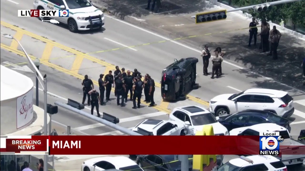 Miami police vehicle rolls over - YouTube