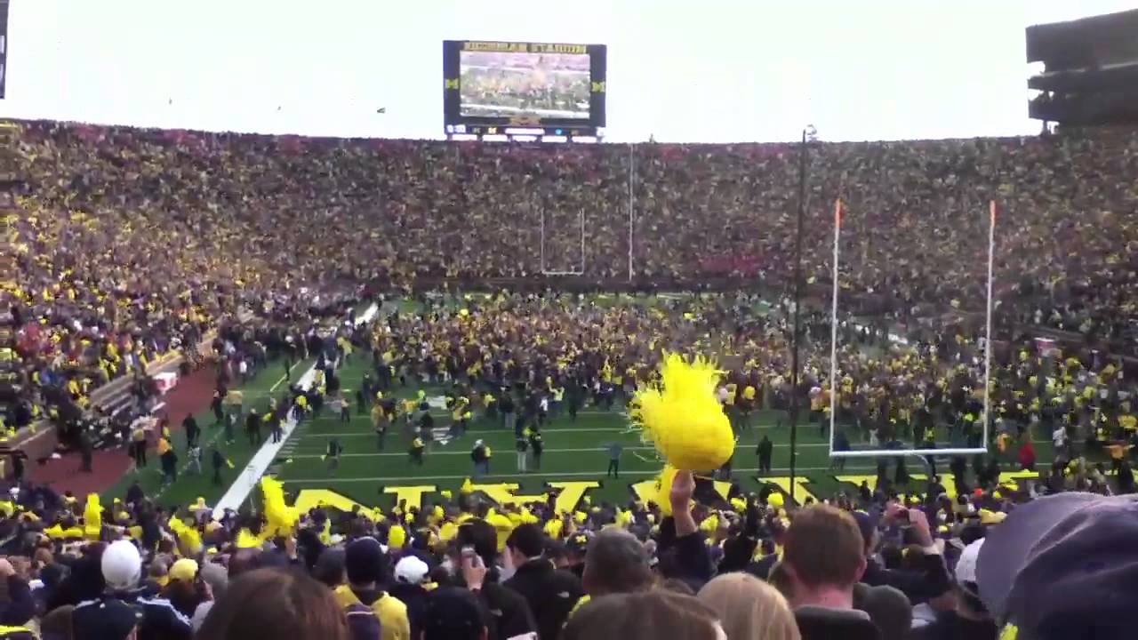 Michigan fans storm the field after a win against rival Ohi - YouTube