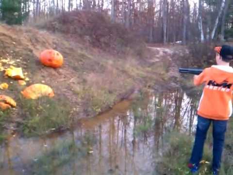 Kid shooting pumpkins with 12 gauge mossberg shot gun pistol grips ...