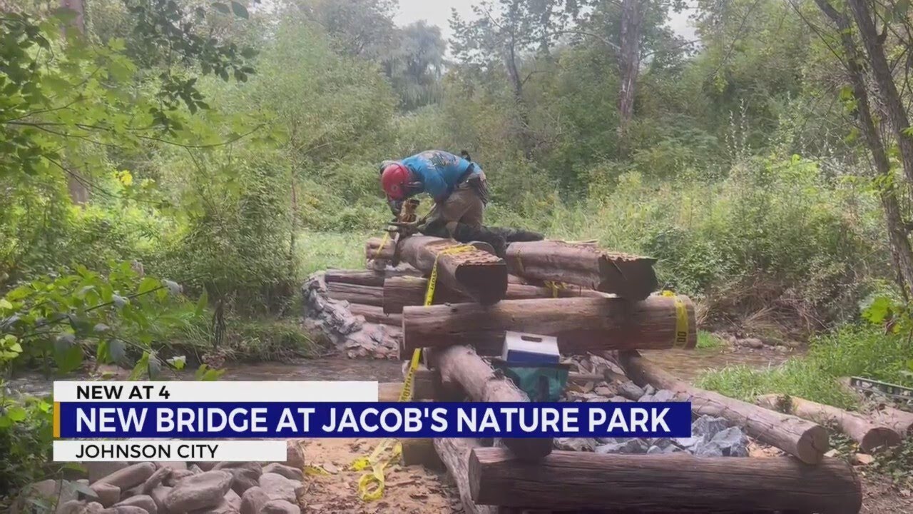 Volunteers near completion on new Jacob's Park bridge - YouTube