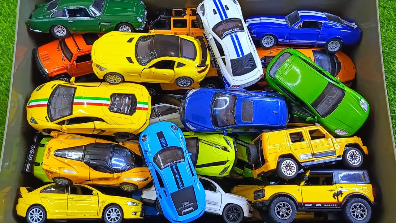 Box full of various miniature cars Jaguar, Peugeot, Renault, Hyundai ...