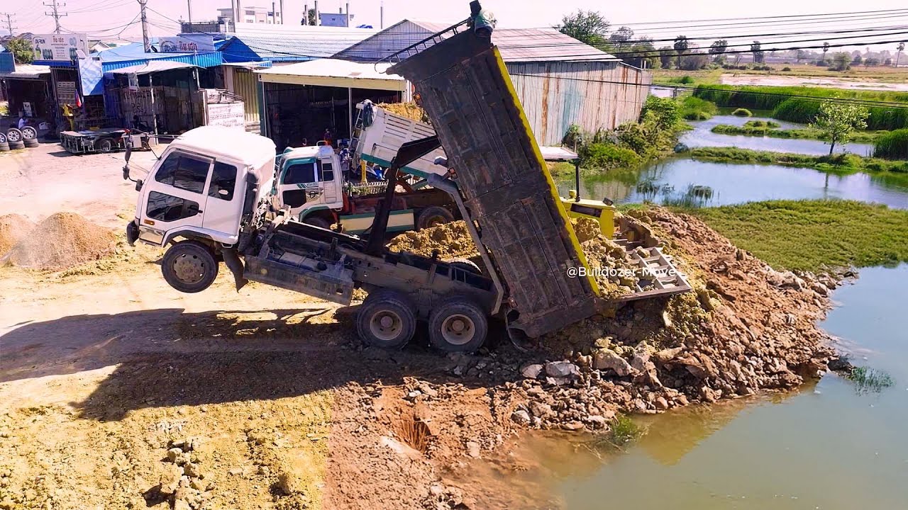 Watch These MASSIVE Dump Trucks Fill An Entire River Bank! - YouTube
