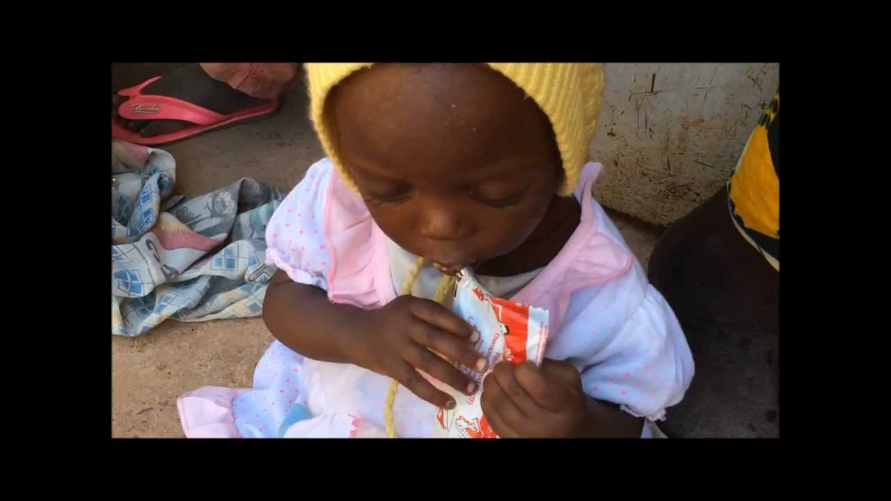 Little girl eating Plumpy'Nut in Burkina Faso - YouTube