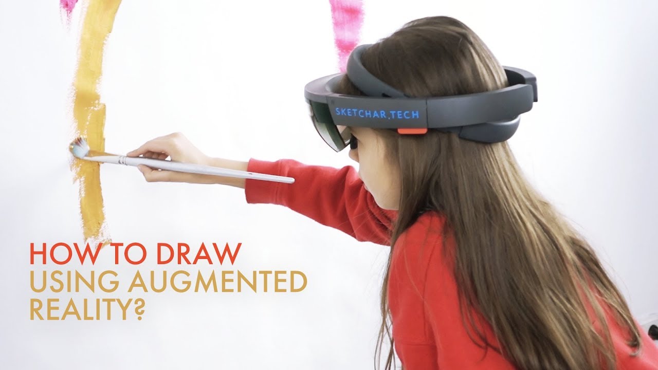 A kid paints a portrait using augmented reality and HoloLens. An ...