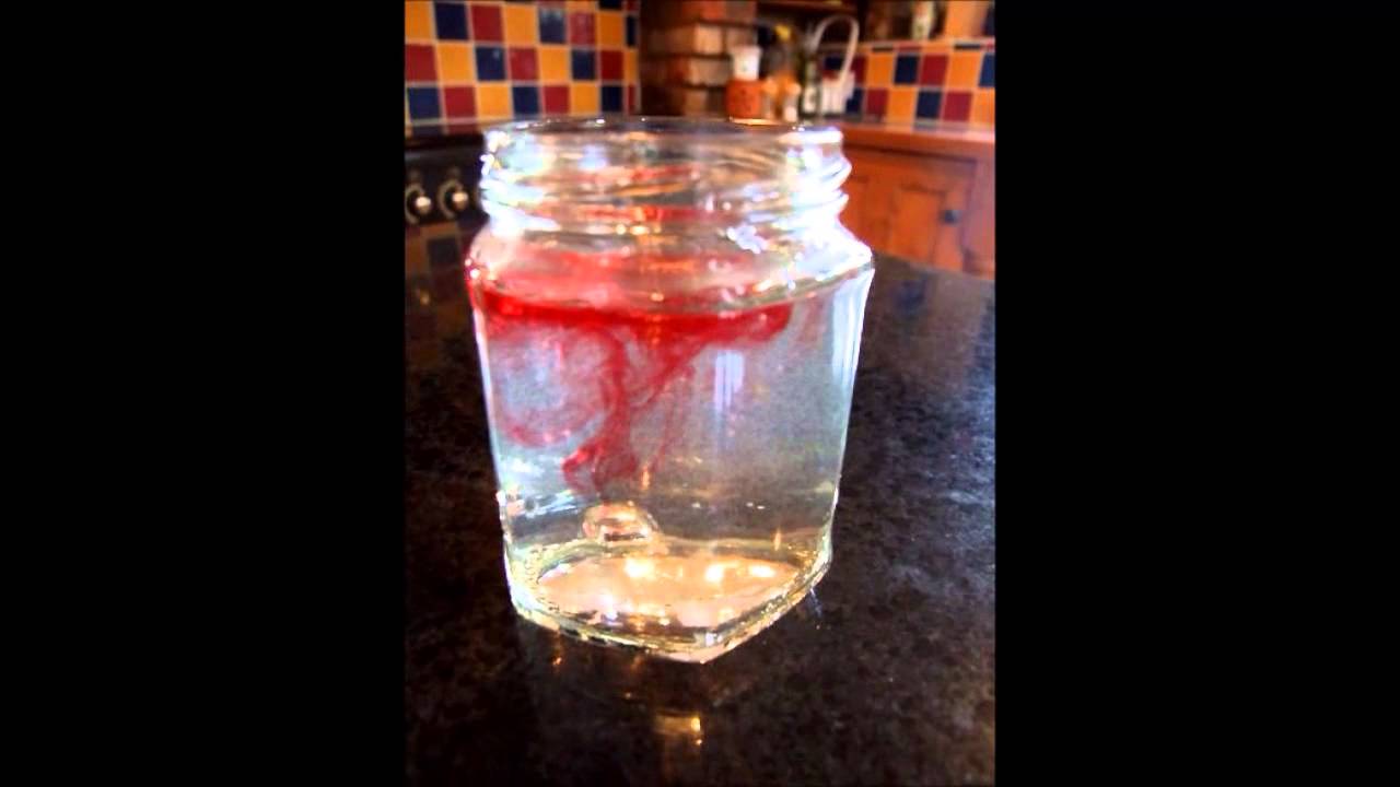 Red food colouring into water - YouTube