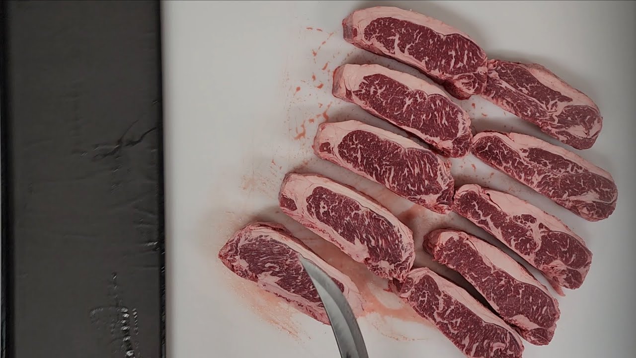 Cutting a USDA Prime Grade striploin into strip steaks - YouTube