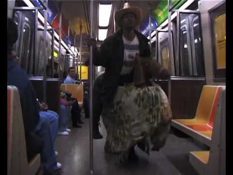 "Man singing and dancing on a horse in a New York City subway train ...